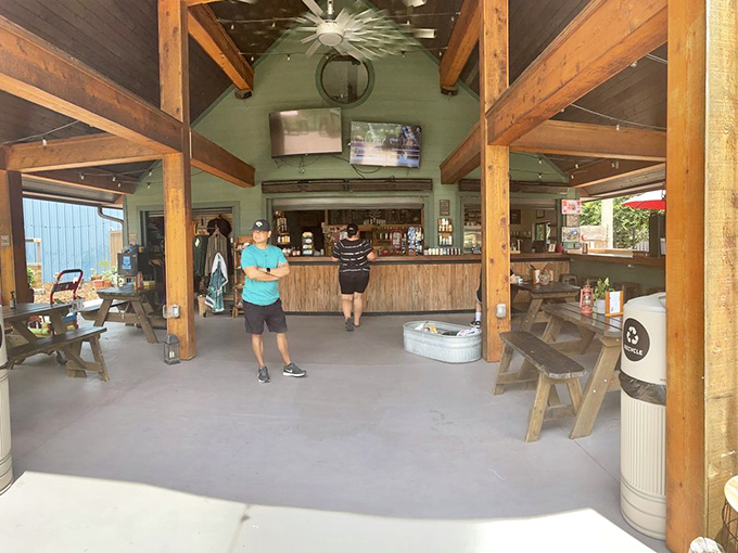 Rustic wooden beams frame this spacious covered area where visitors can escape the sun while keeping an eye on their four-legged friends.