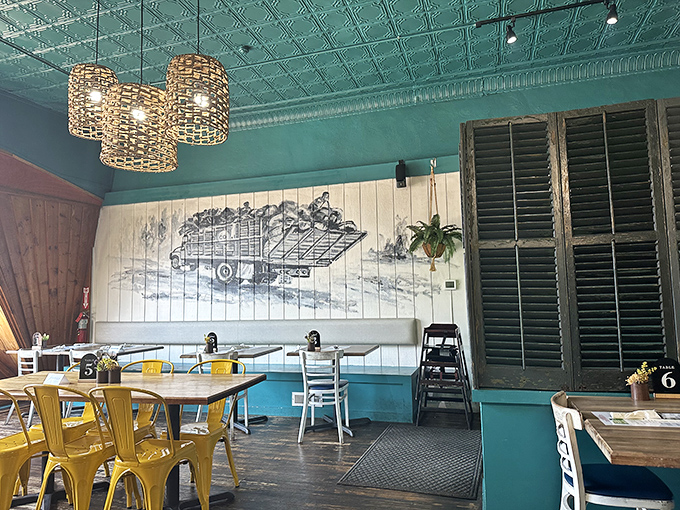 The dining area's turquoise ceiling and natural wood create an underwater-meets-island vibe that makes every meal feel like a special occasion.