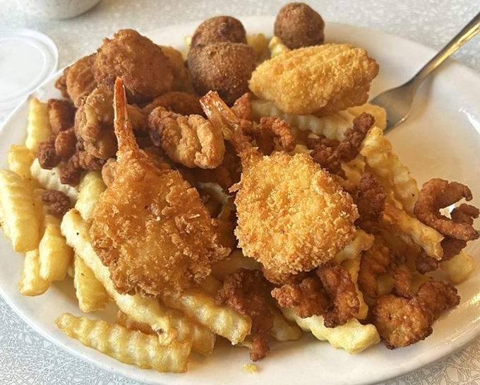 The fisherman's basket that makes you question why anyone would eat seafood any other way. Golden-fried treasures from the deep, with hush puppies standing guard.