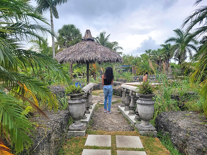 A stone-lined pathway leads visitors through lush gardens, promising quiet discoveries around every verdant corner.