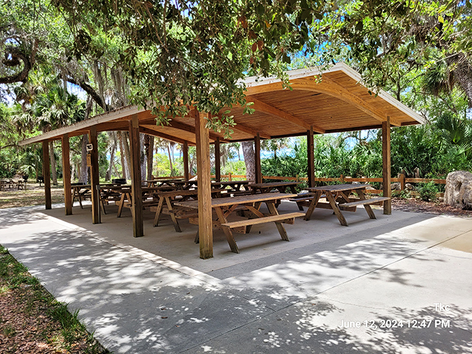 This shaded pavilion offers respite from Florida's sunshine, where picnics become memorable feasts under the watchful gaze of ancient oaks.
