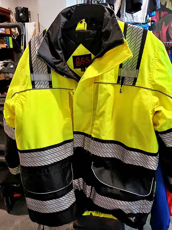 This high-visibility safety jacket stands ready for its second career, proving that even practical workwear gets a chance at reincarnation in this thrifter's paradise.