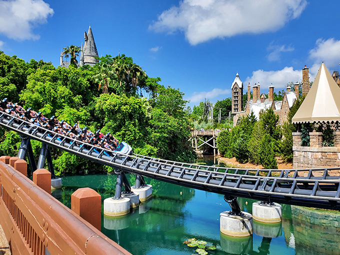 Coaster tracks dance over tranquil waters, creating that perfect theme park contrast: serene beauty interrupted by screaming passengers every 90 seconds.