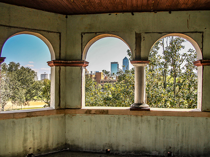 Arched windows frame Jacksonville's evolving skyline, a perfect metaphor for the mansion's role as witness to a century of urban transformation.