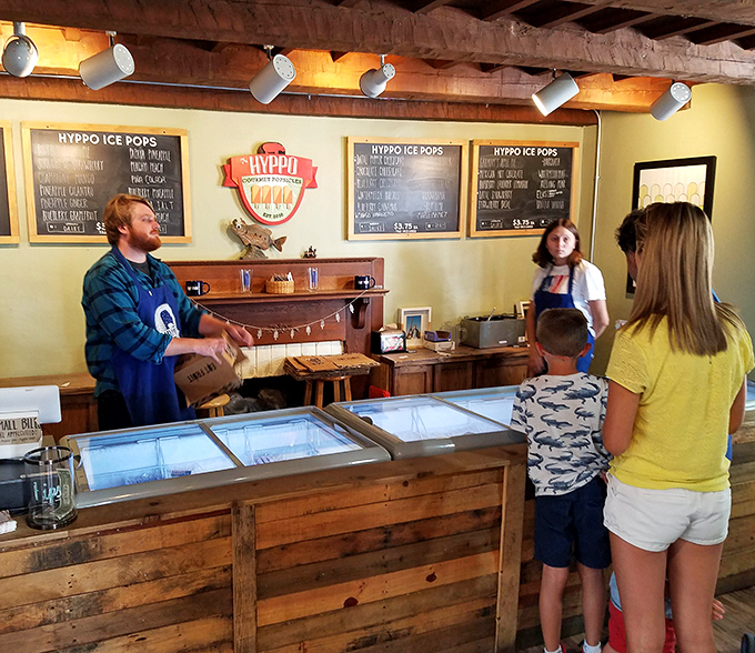Behind this rustic wooden counter, popsicle magic happens daily &ndash; where friendly staff serve as guides on your expedition through flavor country.
