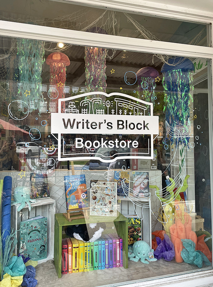 Ocean-inspired window decorations transform the storefront into an underwater reading adventure, complete with colorful jellyfish and sea creatures swimming among the books.