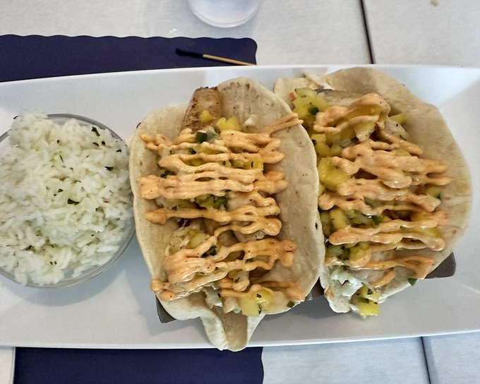 Fresh catch wrapped in soft tortillas with house-made toppings – portable vacation bites that deliver Gulf flavors in every mouthful.