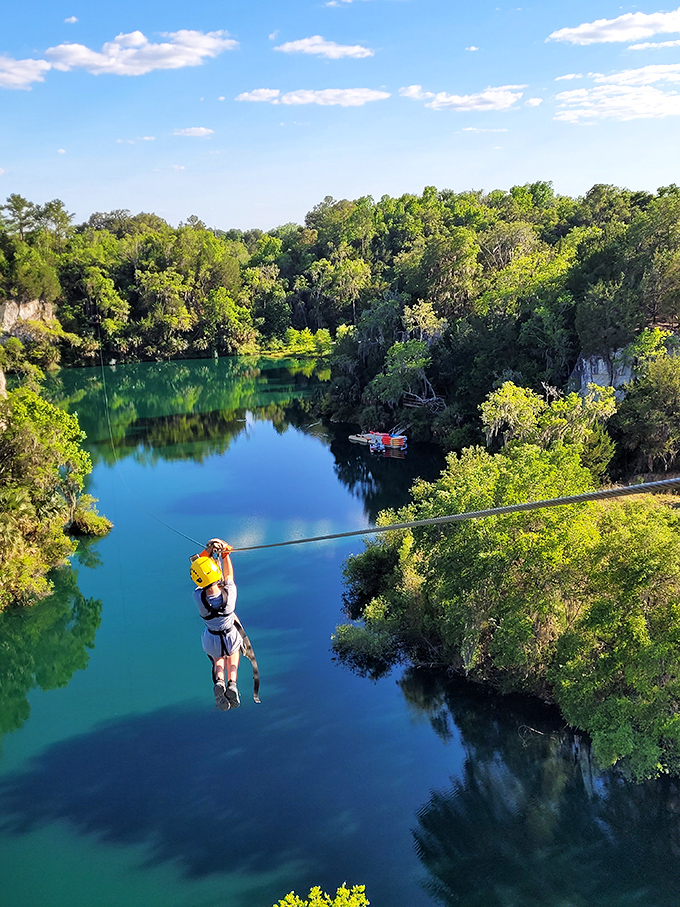 Soaring above emerald waters at The Canyons Zip Line &ndash; where limestone quarries have transformed into adventure playgrounds.