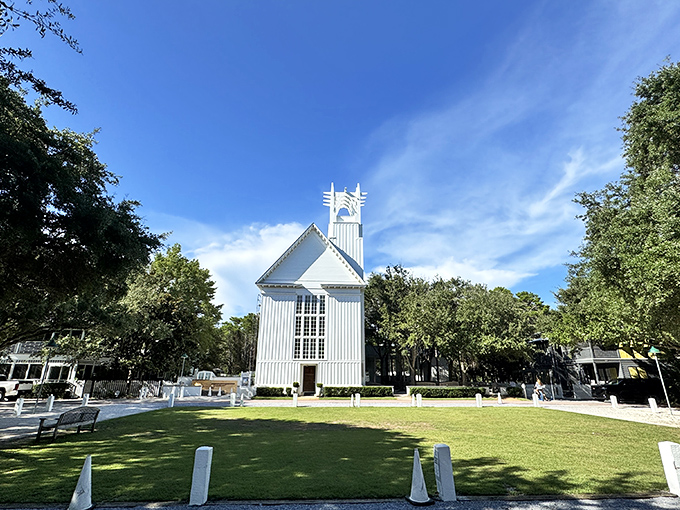 
The Chapel at Seaside stands pristine against blue skies, its white walls and simple elegance making even atheists consider attending a service.
