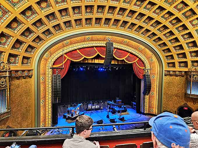 The magnificent proscenium arch frames the stage like a gilded portal to other worlds, inviting audiences to forget reality for a few precious hours.