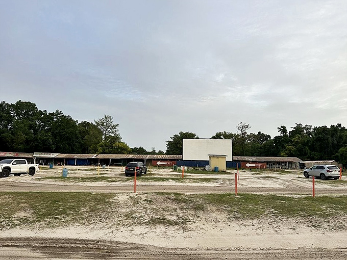 The massive screen awaits dusk's embrace, standing tall against the landscape like a monument to America's love affair with movies.