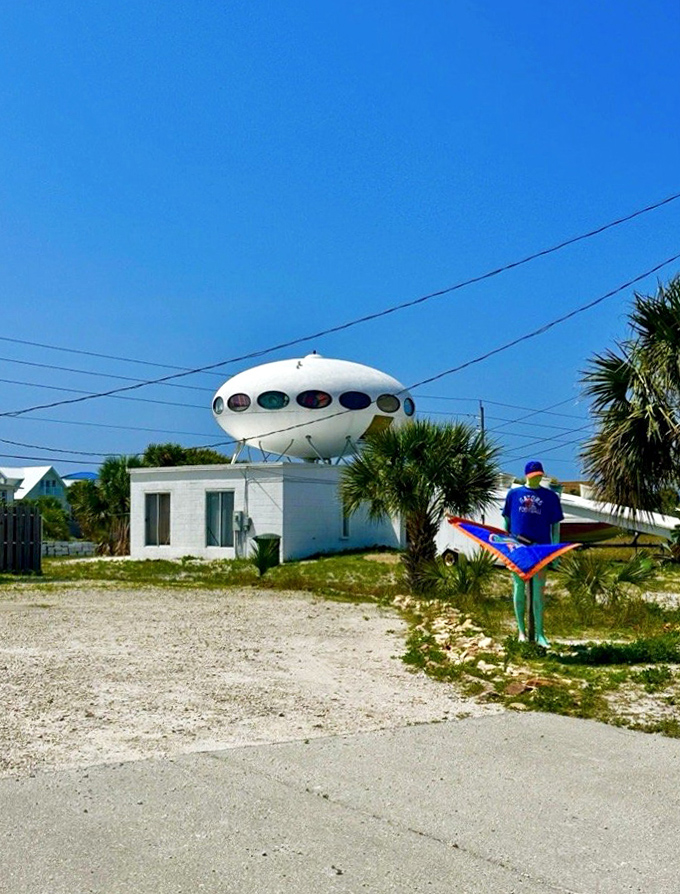 A colorful yard display adds to the whimsical atmosphere—because if you've got a UFO house, why not embrace the theme?