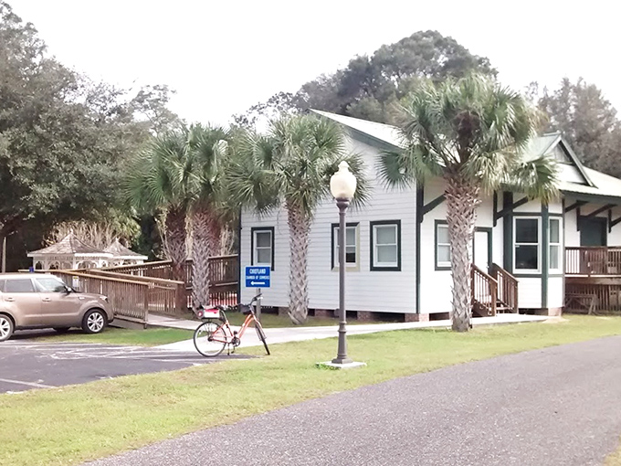 Palm trees frame this white building in the historical complex, blending Florida's natural beauty with its preserved past.