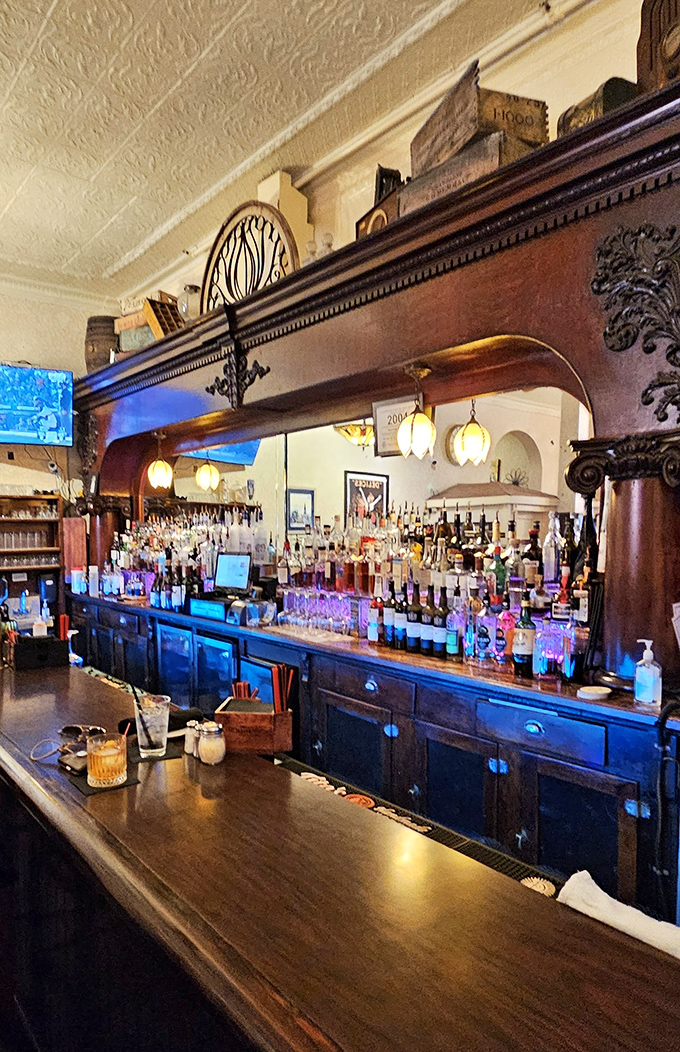 Bar: Behind this historic wooden bar, bottles glimmer like jewels while the bartender orchestrates liquid happiness with practiced hands.