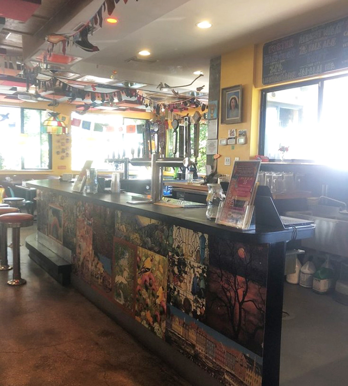 The command center of quirkiness, where colorful pennants hang overhead and every surface tells a story through creative collage work.