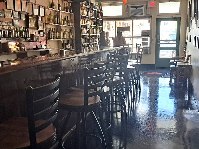 The bar area invites patrons to pull up a stool and settle in for stories and spirits. Bottles lining the back wall promise libations for every taste.