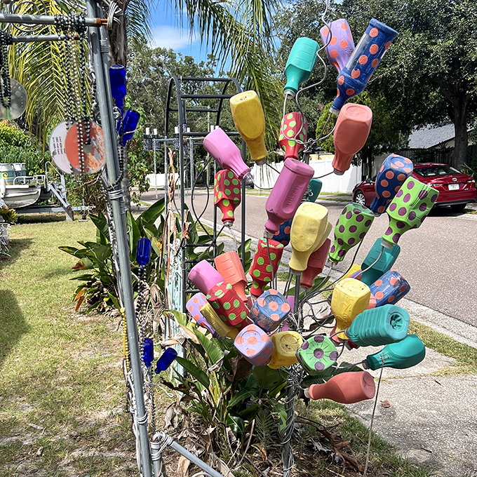 These bottles caught sunlight instead of dust, transformed into a technicolor tree that makes conventional landscaping seem hopelessly boring.