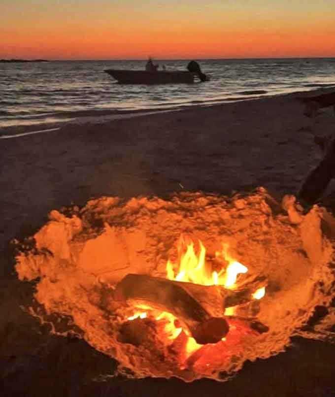 A beachside campfire at sunset is nature's way of saying you made excellent life decisions today, and you should probably do this more often.