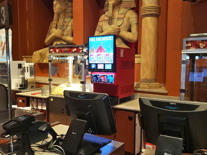 Ancient Egyptian statues stand guard at the concession counter, silently judging your candy-to-popcorn ratio decisions.