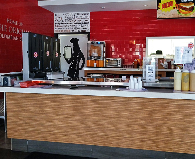 The counter where dreams come true&mdash;gleaming red tile, wooden accents, and the promise of Colombian culinary magic just moments away.