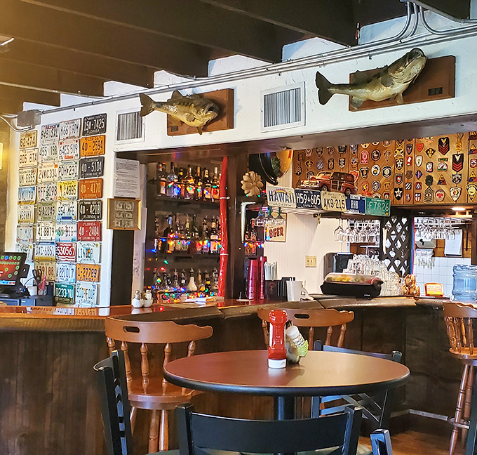 The bar area showcases decades of collected license plates and memorabilia, making every glance reveal something new while you sip your drink.