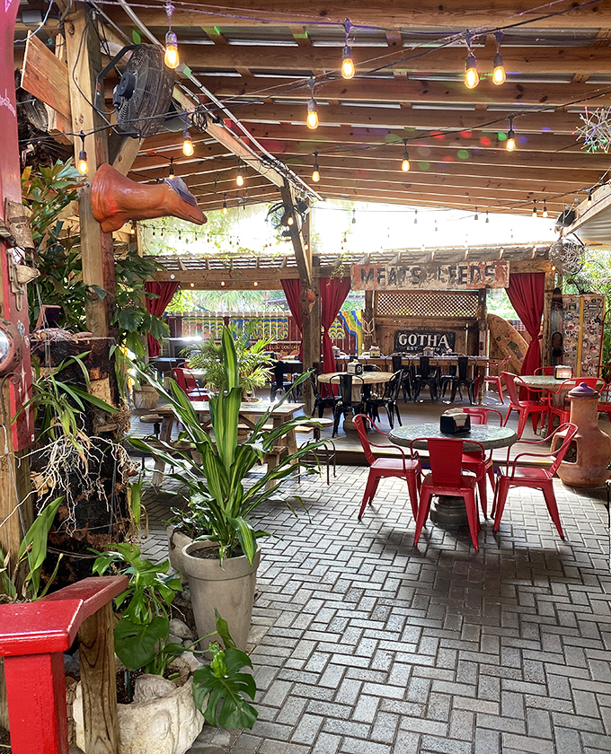 The covered outdoor seating area feels like dining in a secret garden, with string lights, lush plants, and the kind of atmosphere that makes you want to linger for hours.