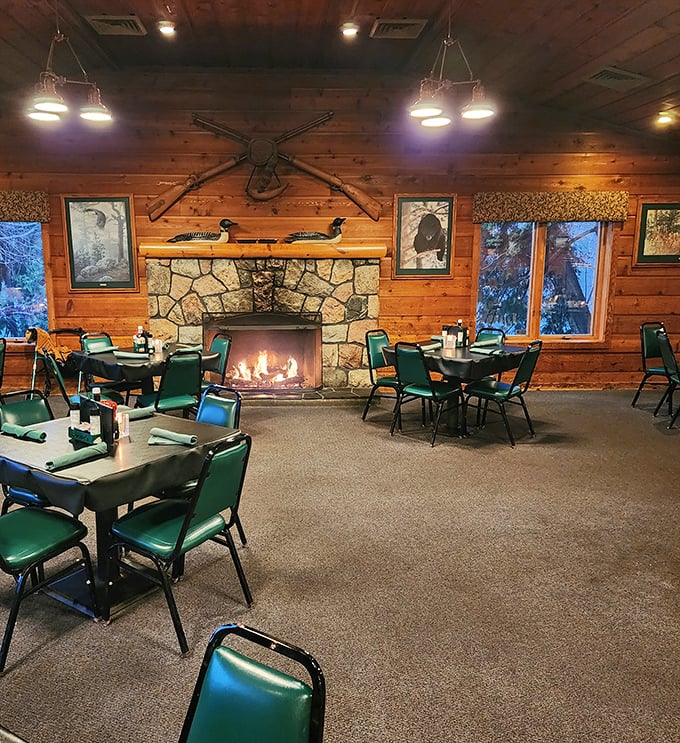The dining area's stone fireplace becomes the room's natural focal point as evening settles in &ndash; nature's television before Netflix existed.