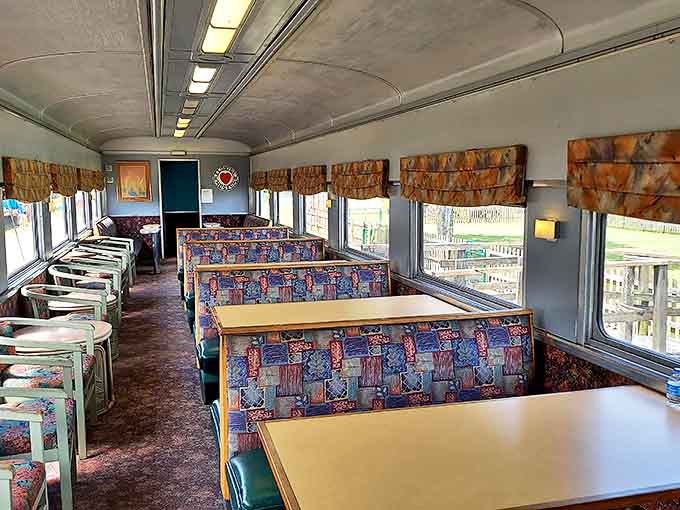 Dining area interior: Vintage dining car seating invites visitors to imagine elegant meals served while countryside views rolled past these very windows decades ago.