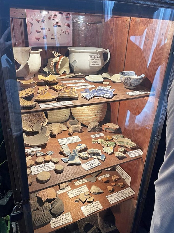 Artifact Collection: Centuries of history displayed behind glass &ndash; pottery fragments and everyday items tell stories of colonial life through tangible remains.