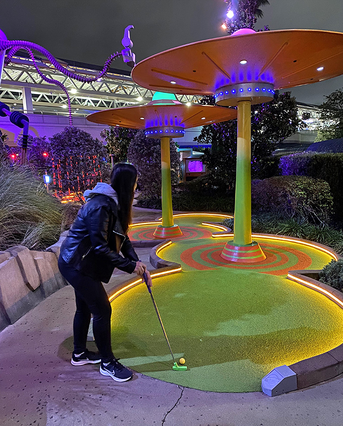 The courses transform magically after dark, with illuminated features creating an otherworldly glow that enhances the B-movie atmosphere.