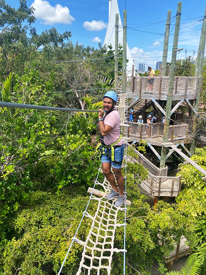 "Look Ma, no hands!" might cross your mind, but thankfully the safety harness keeps this smiling adventurer securely connected.