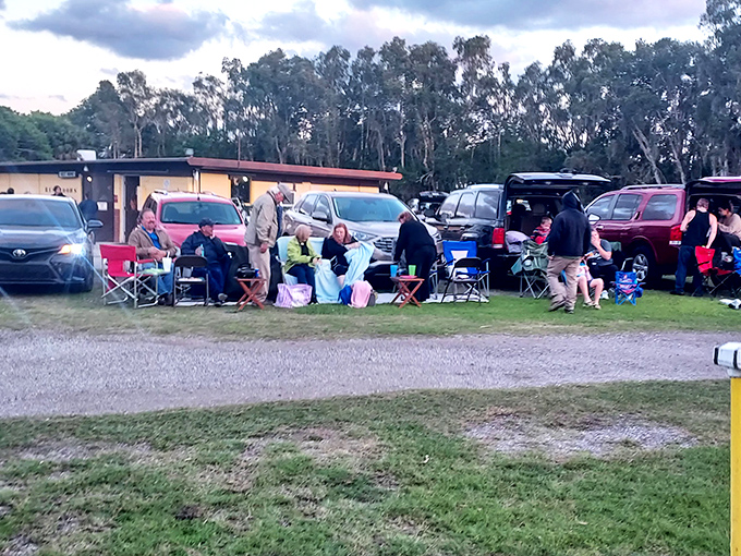 Lawn chairs, blankets, and community spirit – the drive-in transforms strangers into neighbors under the silver screen's glow.