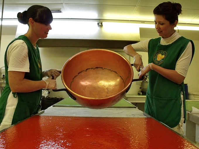 Candy artisans tend to a copper kettle &ndash; the ancient alchemy of transforming fruit and sugar into edible joy.