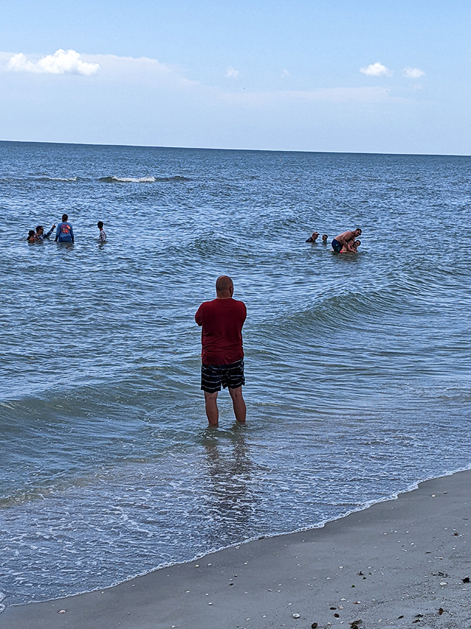 Visitors cool off in the refreshing Gulf waters after a successful morning of shell collecting under the Florida sun.