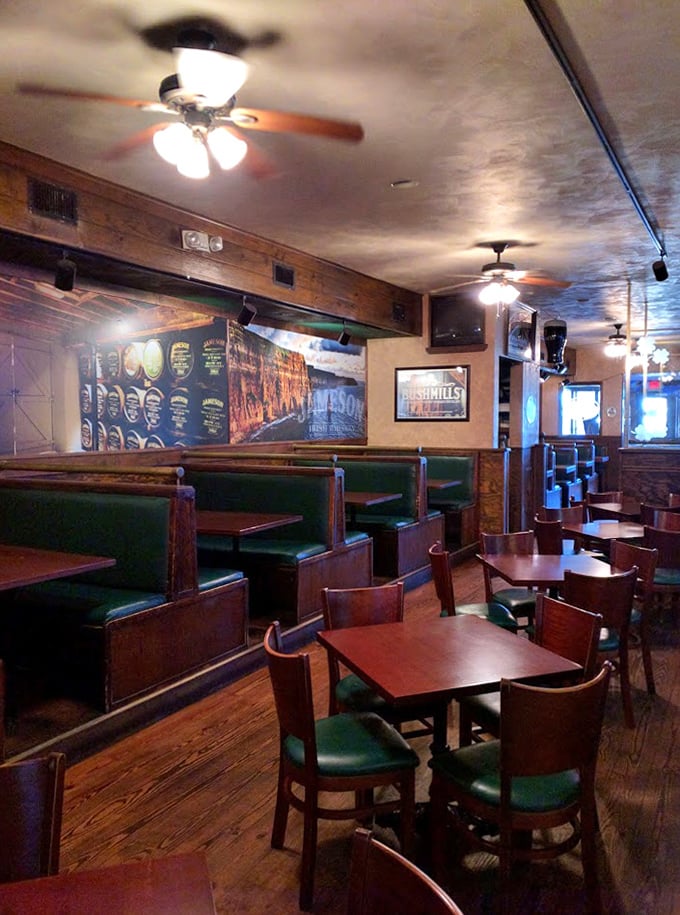 The dining area strikes that perfect balance between cozy and spacious, with rich woods and green accents creating authentic pub atmosphere.