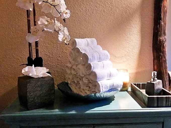 Pristine white towels stacked with military precision, standing by for their noble duty in the war against tension and stress.