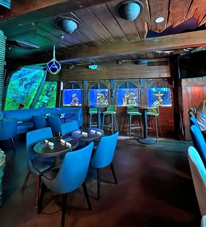 Another interior angle: Cozy blue seating and ambient lighting create intimate conversation nooks, perfect for discussing whether you could hold your breath that long.