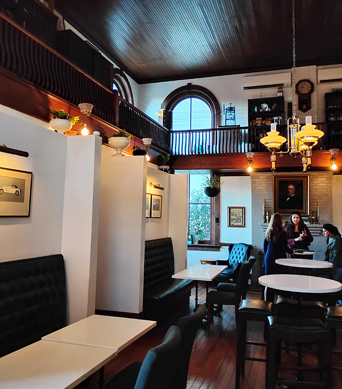 Historical haven: Arched windows and a wraparound balcony create architectural interest while leather banquettes offer cozy corners for intimate conversations.