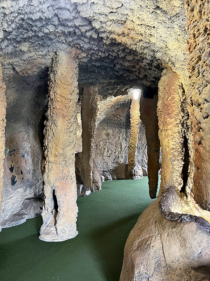 Artificial cave: Journey through alien caverns where stalactites hang like frozen tentacles. The green carpet guides brave putters through this otherworldly passage.
