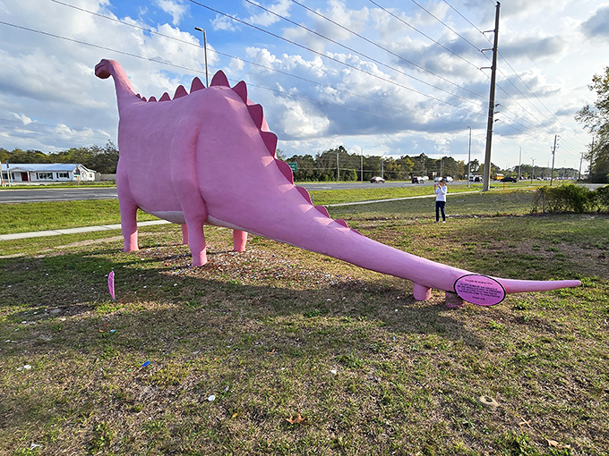 The dinosaur's impressive tail stretches out behind it, completing the prehistoric silhouette that's become a local icon.