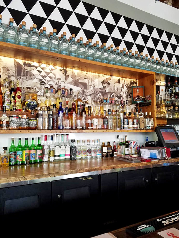 The bar's wooden shelves showcase an impressive tequila library, each bottle promising stories from different Mexican regions.