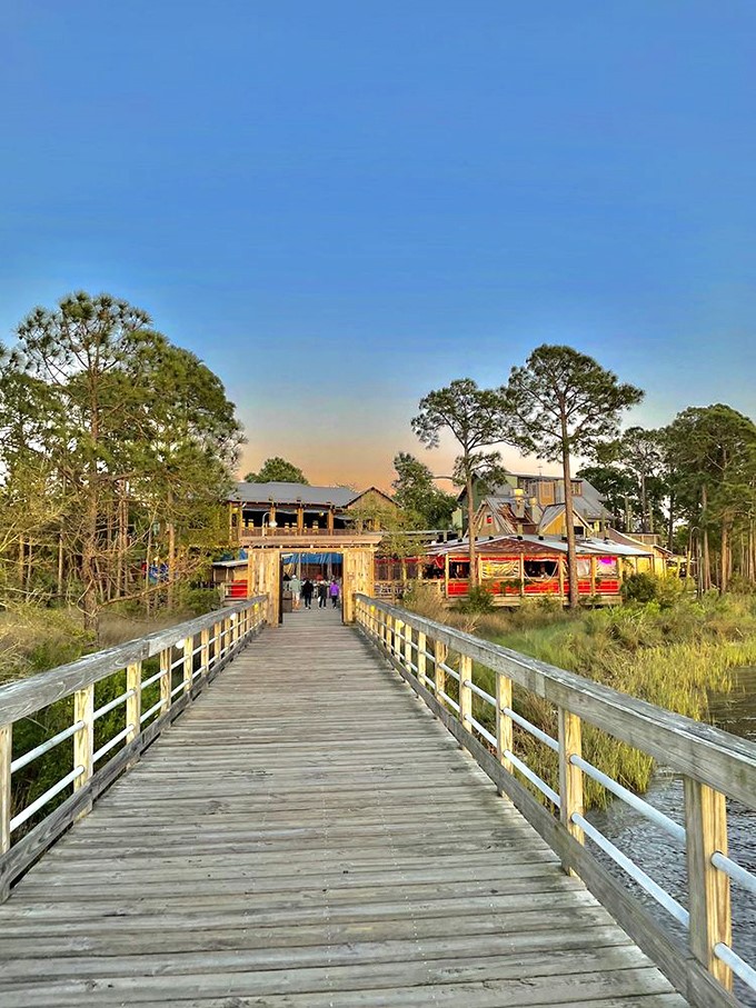 A wooden boardwalk leads to colorful buildings at sunset, creating that "should we move here?" moment every good vacation destination inspires.