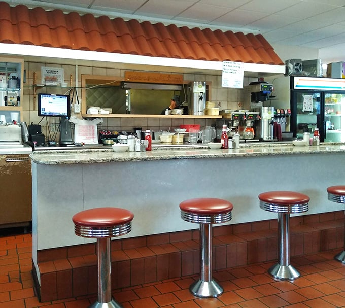 Where solo diners find community, regulars claim their territory, and everyone gets a front-row seat to the breakfast ballet.