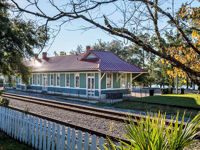 The meticulously preserved train depot stands as a Victorian time capsule, its colorful roof and detailed woodwork recalling an era when travel was an elegant affair.