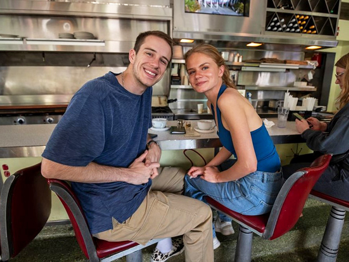 Happy patrons at the counter prove that good food creates good moods, regardless of what's happening outside those diner doors.