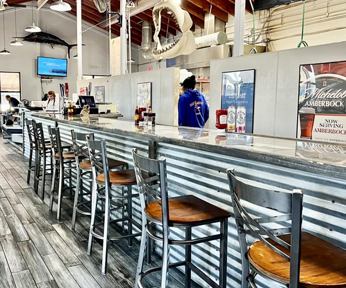 Where seafood pilgrims gather at the altar of fresh catch, watching kitchen wizardry while anticipating their own platters of joy.