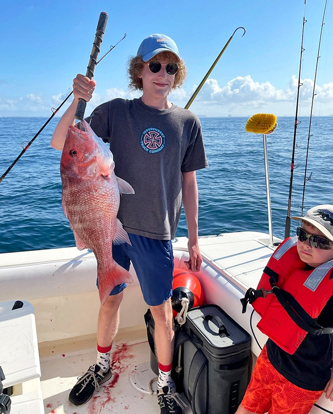 Fishing: A proud angler displays the day's impressive catch &ndash; proof that patience and the Gulf's bounty can make anyone feel like a champion.