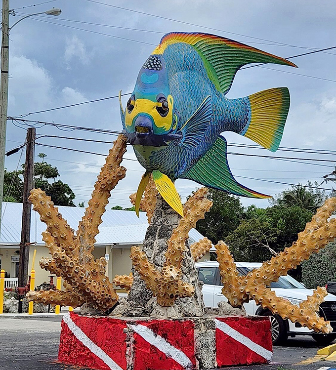 The dive flag base adds nautical authenticity – this fish knows its maritime protocols even while permanently stationed on land.