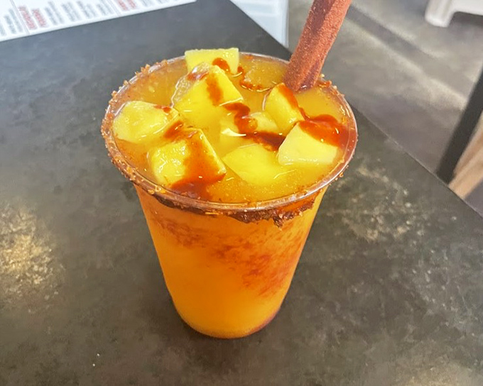 The mangonada &ndash; where fruit meets fire. Chunks of fresh mango swimming in tangy chamoy sauce, with a tamarind candy straw for stirring adventures.