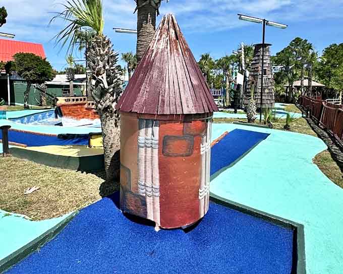 Bright blue putting surfaces wind through the attraction, creating a striking contrast against the whimsical concrete creatures that guard each hole.
